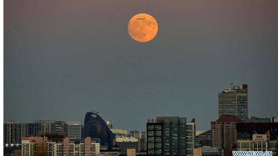 Full moon over buildings in Beijing