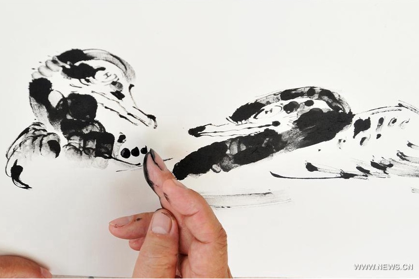 Artist demonstrates finger paintings